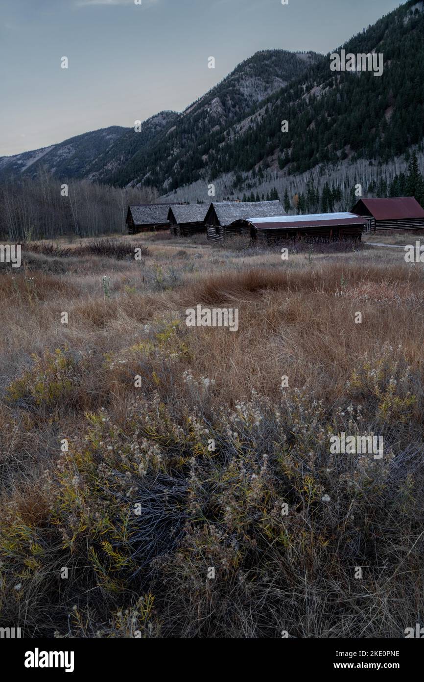 A landscape shot of old abandoned wooden houses in the field in ...