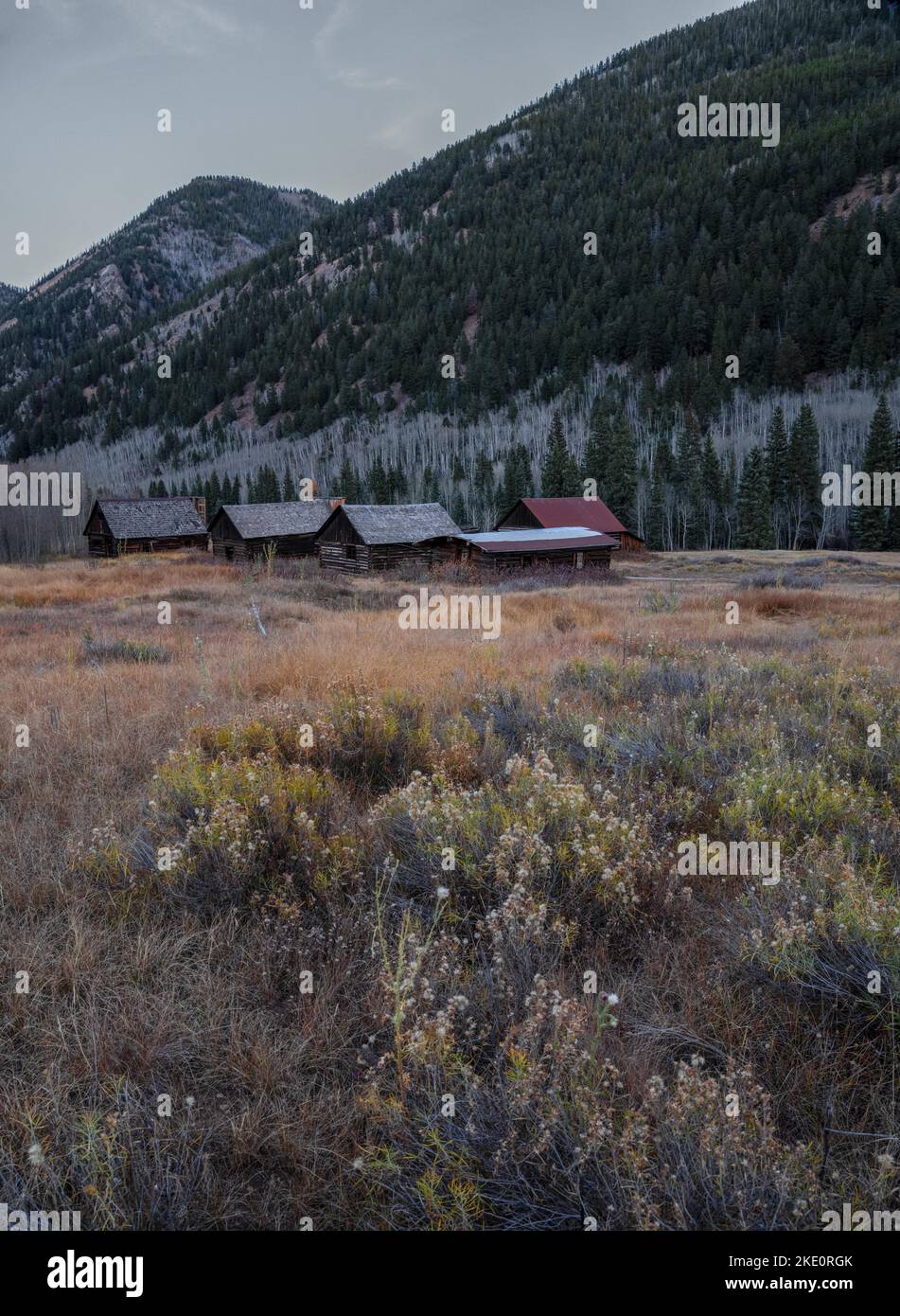 A beautiful shot of cabins on the slope of a mountain with a scenic ...