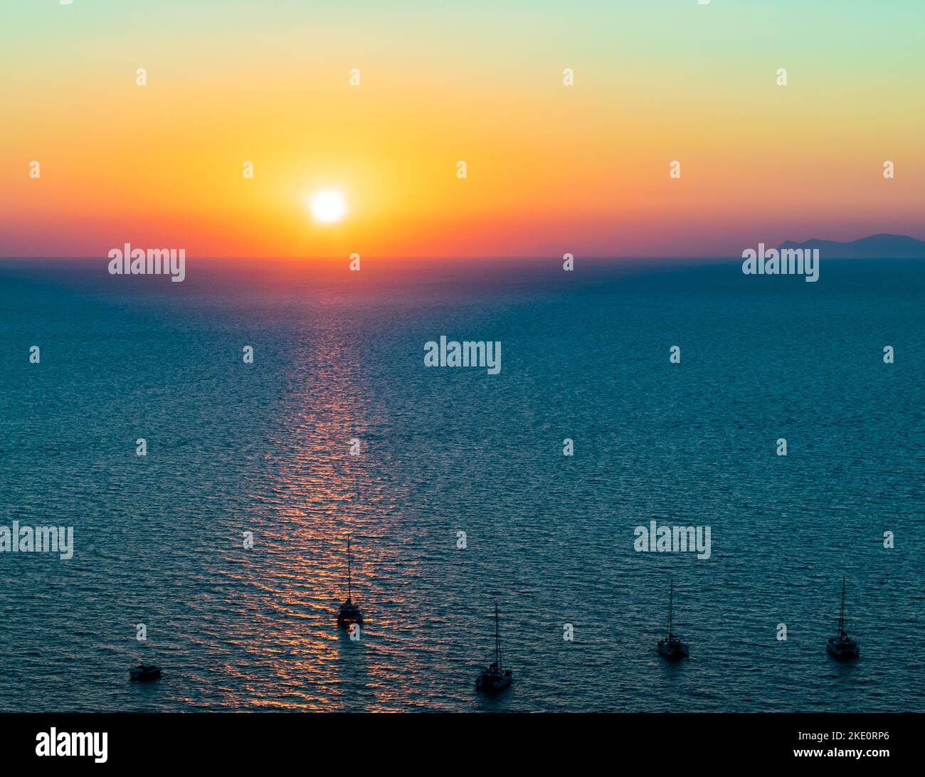 aerial view of sunrise in open calm sea. one boat leads many boats ...
