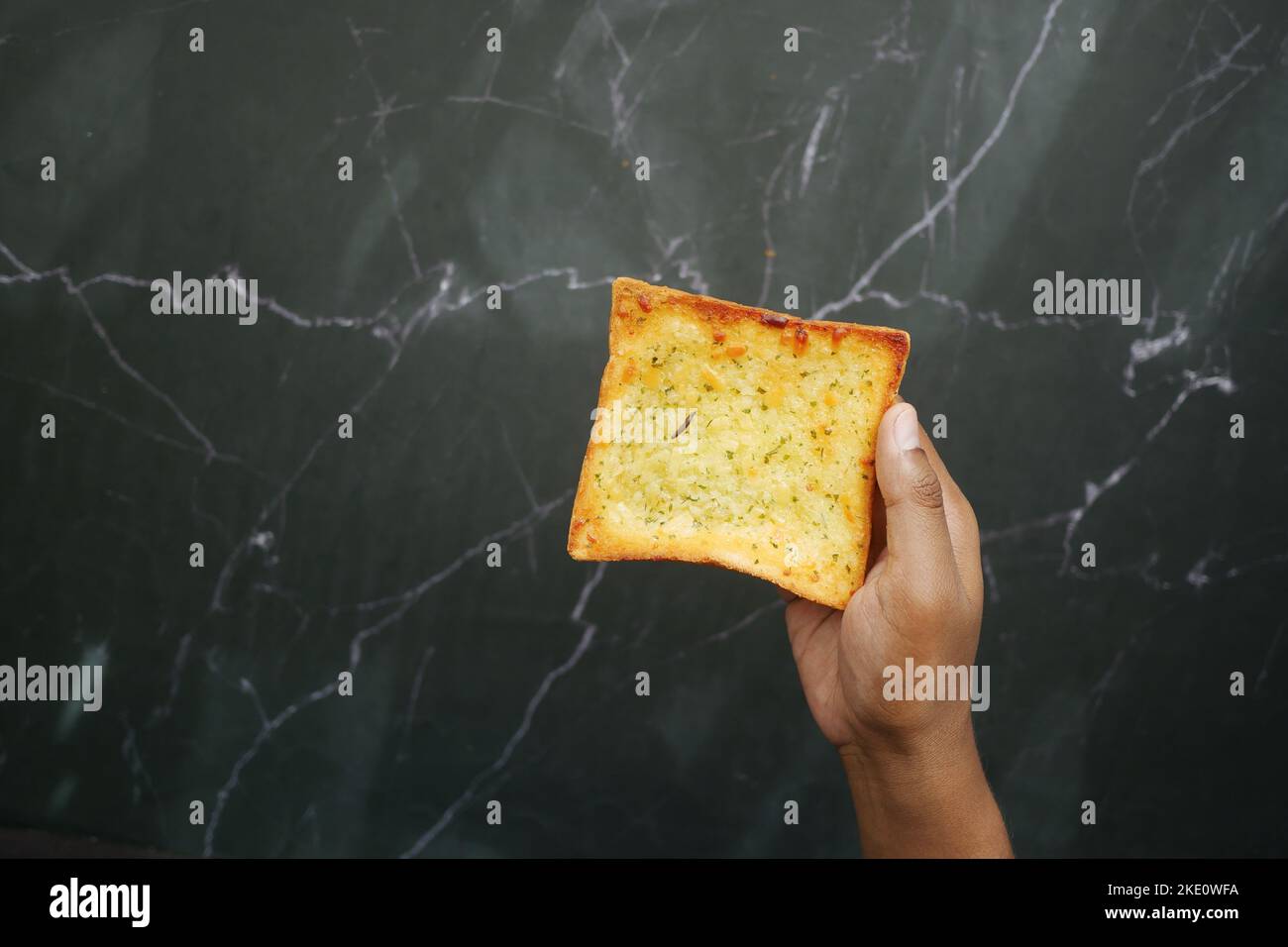 top view of holding a garlic bread Stock Photo - Alamy