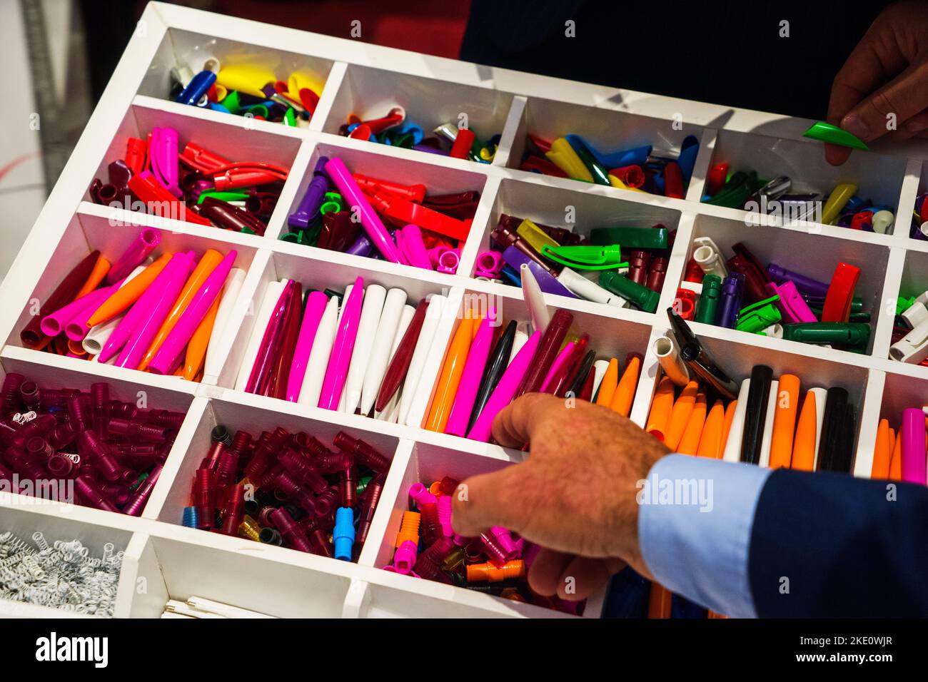 multi-colored plastic disassembled ballpoint pens in boxes, close up ...