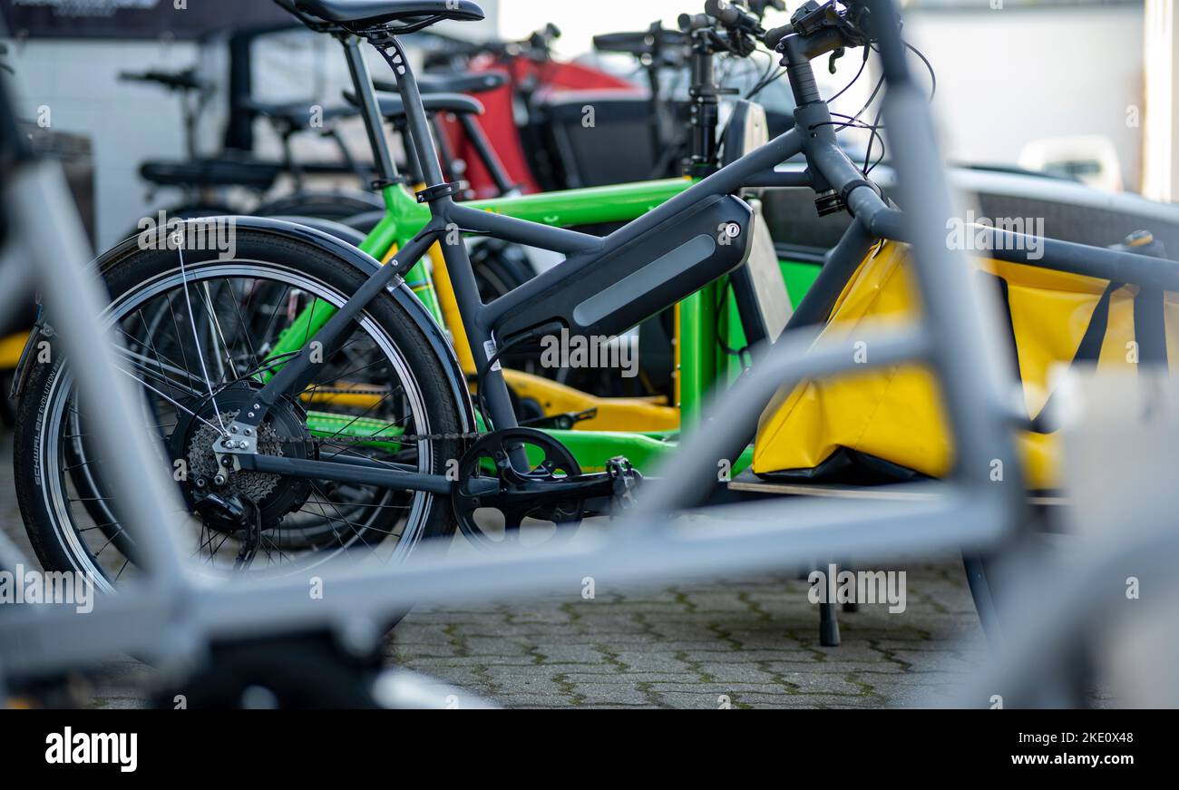 Various cargo bikes parked on cobbled street. Efficient modern vehicles ...