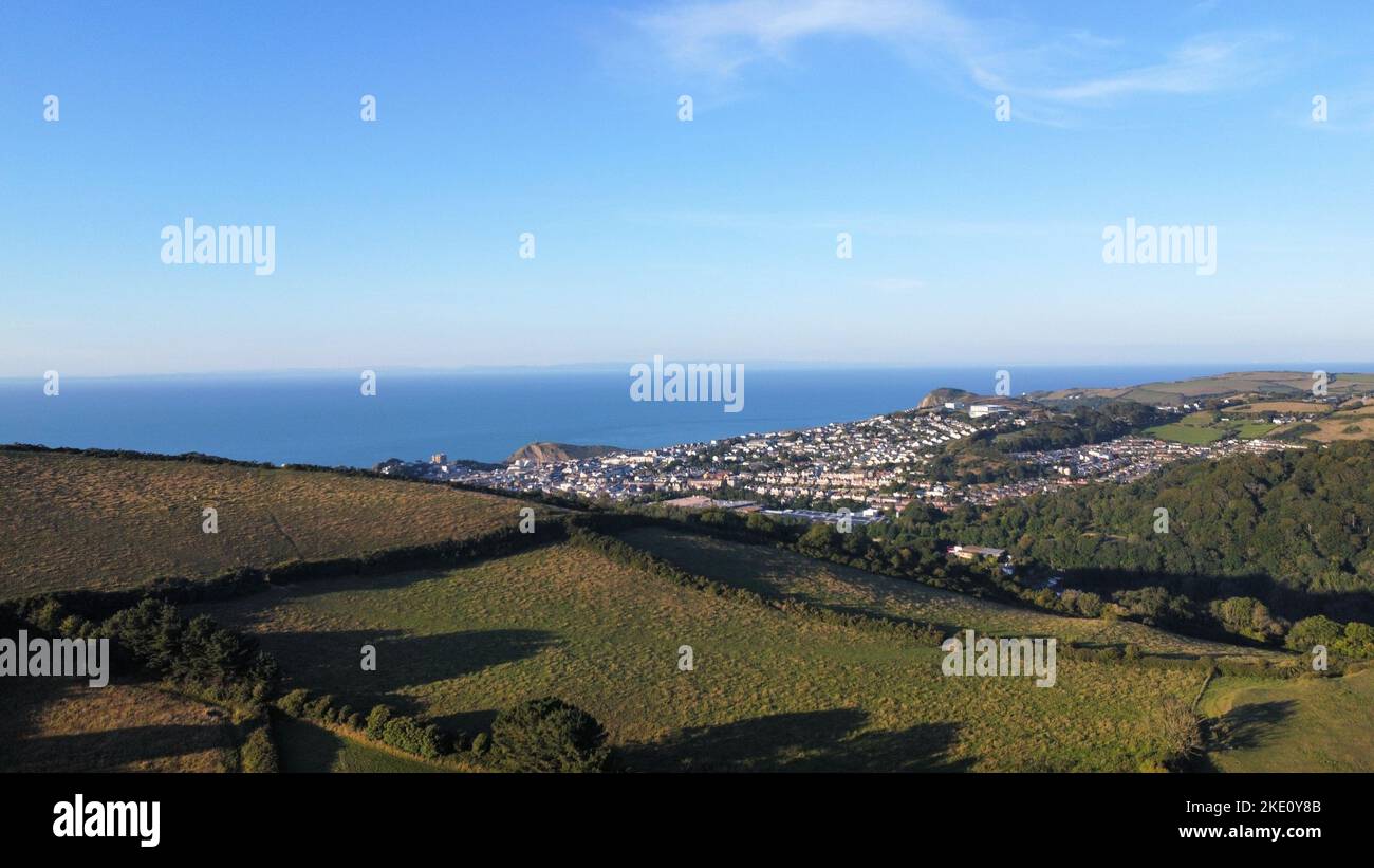 An aerial view of lush green vegetation with seaside Pickering town in ...