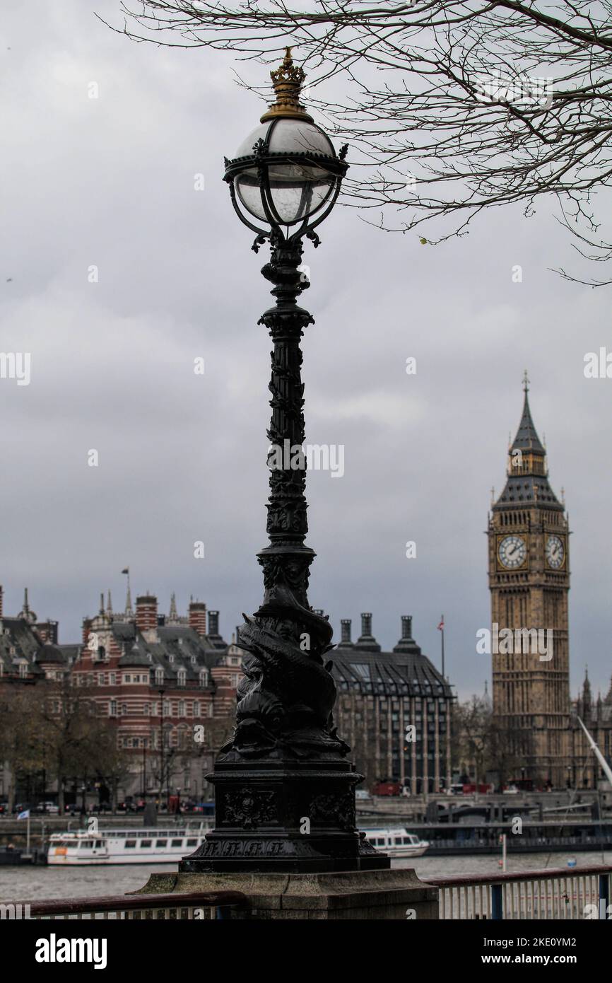 A vertical shot of a street lamp in London with Big Ben tower in the ...