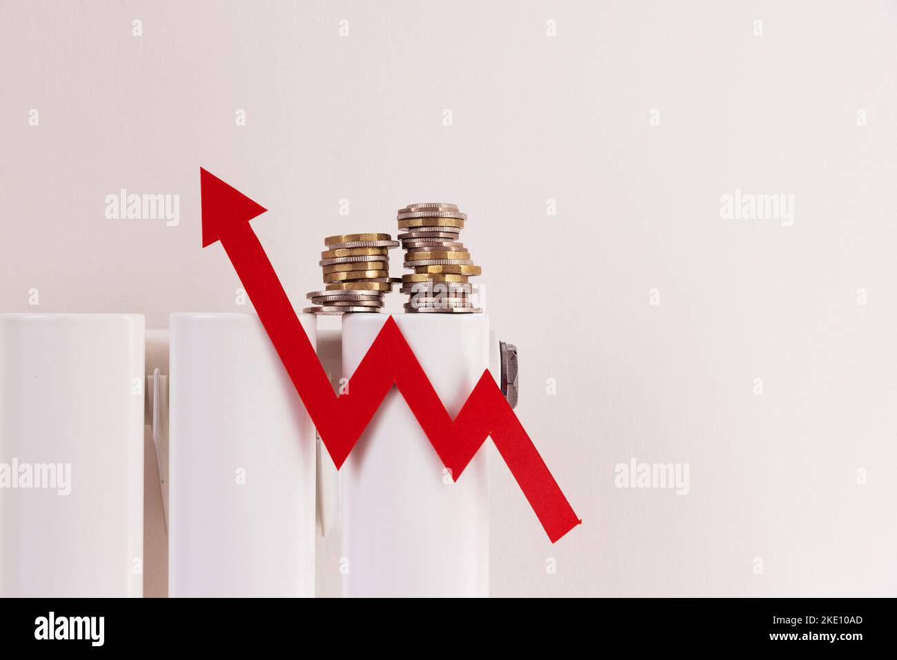 Increasing energy bills. Rising red arrow and coins on a heating ...