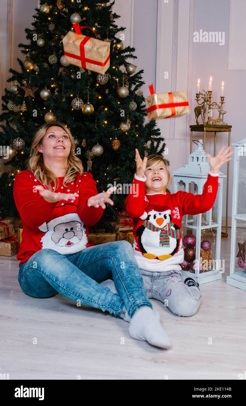 Happy mother and daughter throwing up gift boxes Stock Photo - Alamy