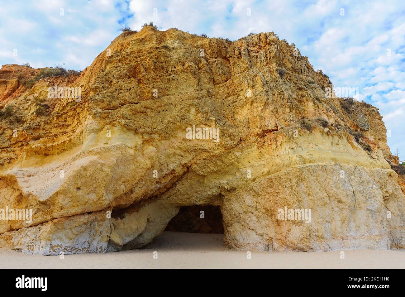 Entrance to a cave under a limestone cliff on Tres Castelos beach in ...