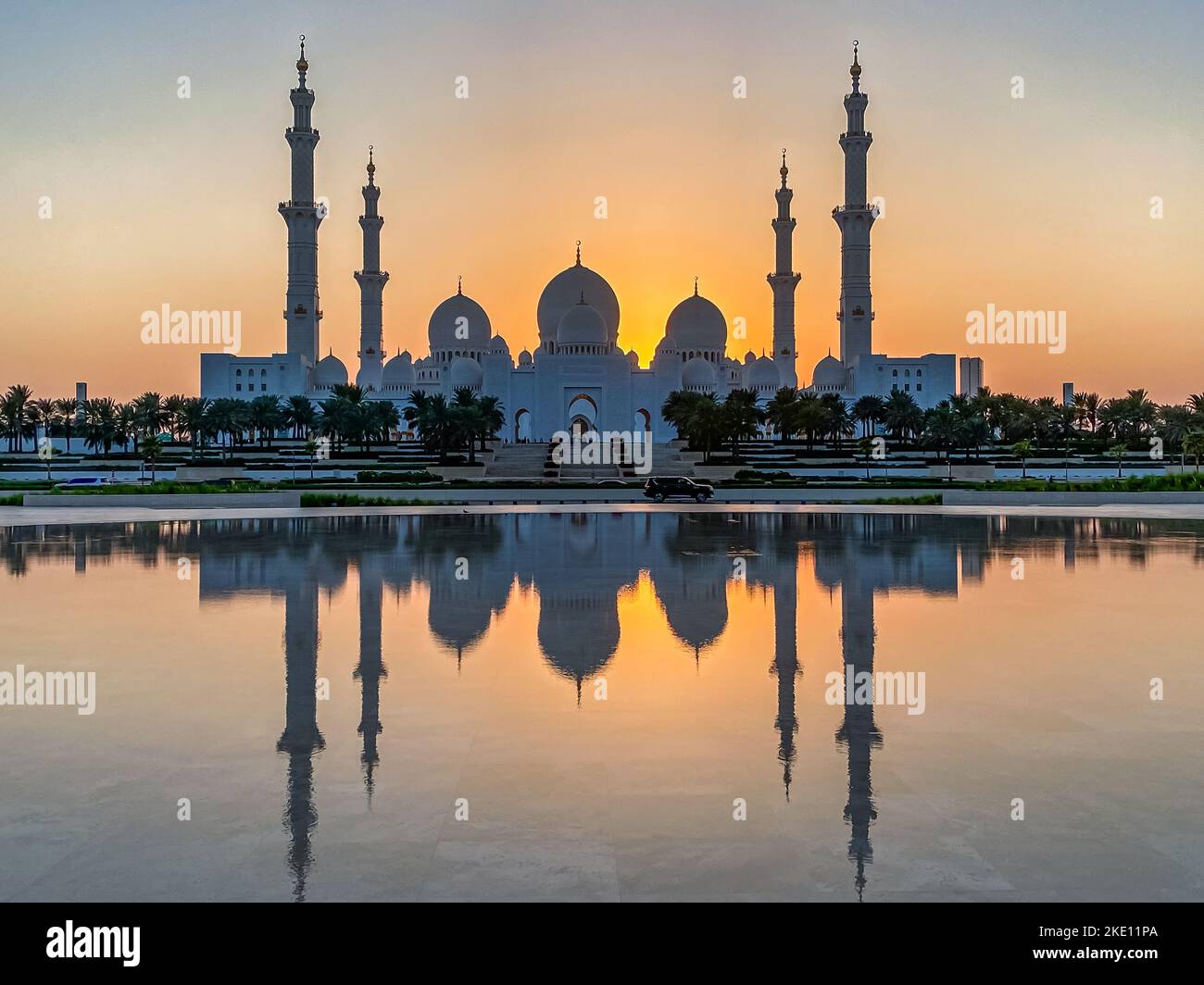 Sheikh Zayed Grand Mosque in Abu Dhabi at sunset as seen from the reflecting pool at the Wahat ...