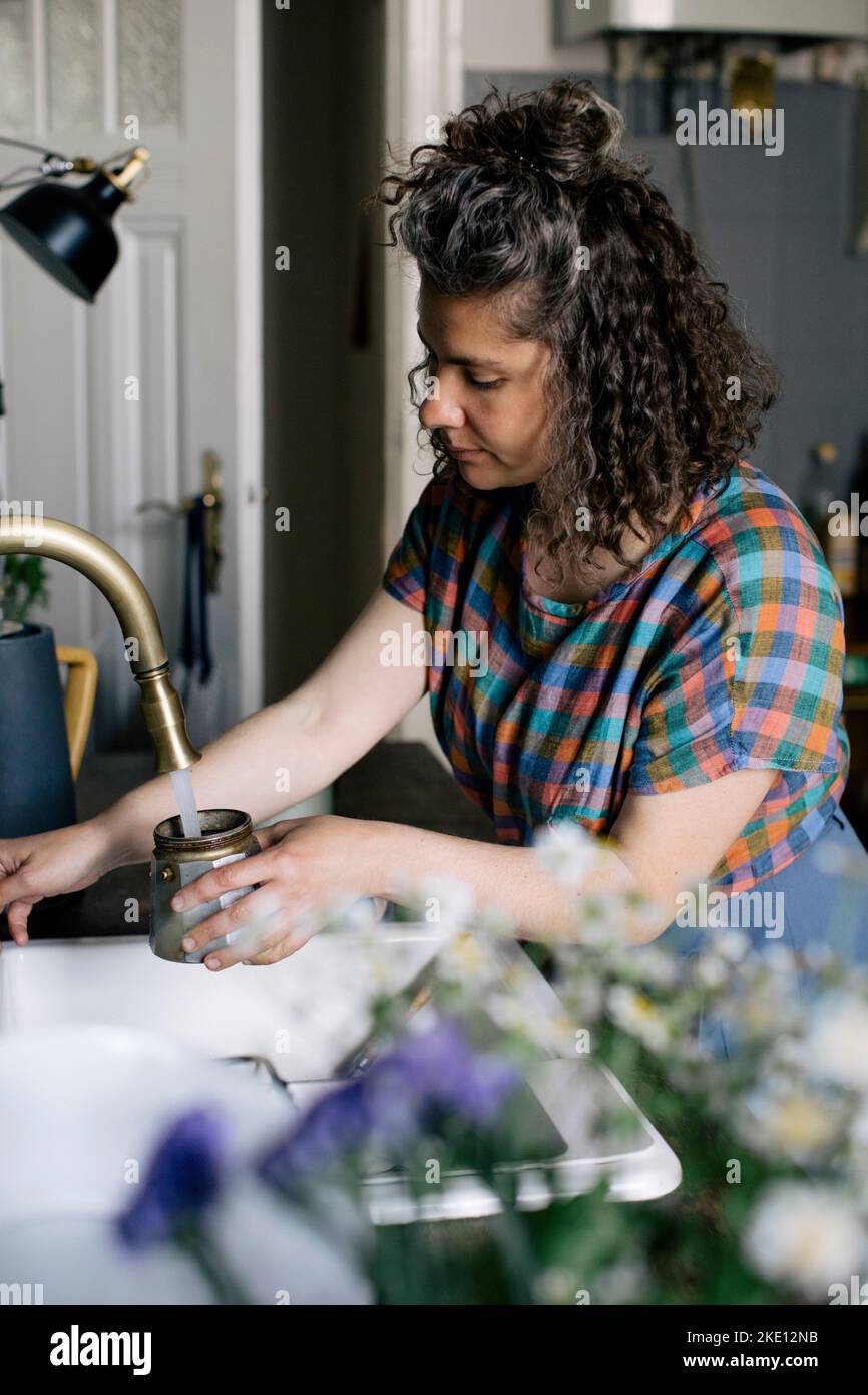 Filling water pot hi-res stock photography and images - Alamy