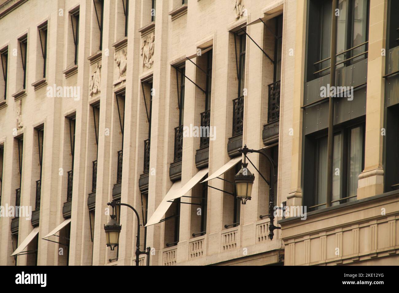 The facade of a beige building with long narrow windows in downtown ...