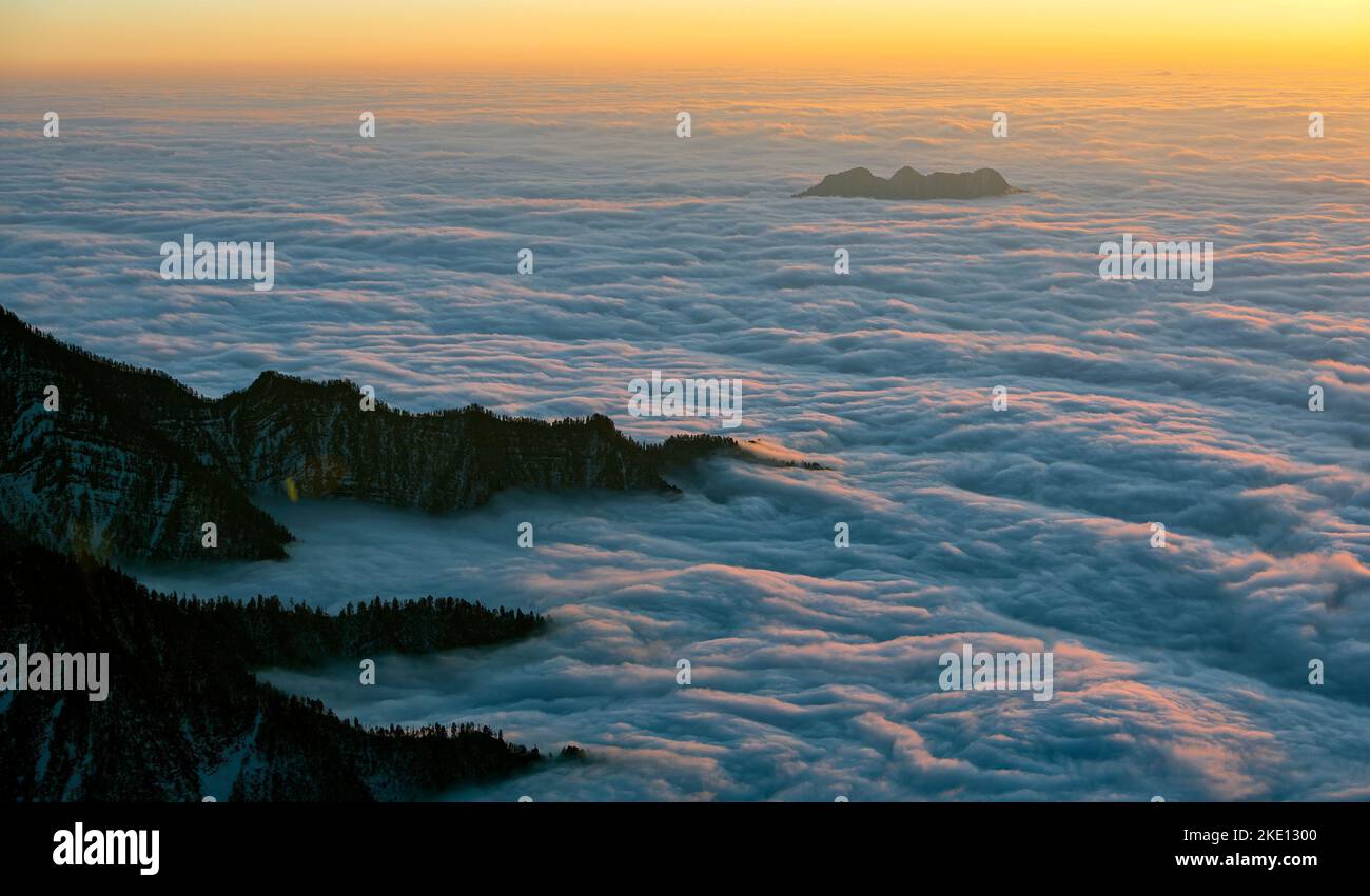 A beautiful shot of mountain peaks covered with forests above the ...