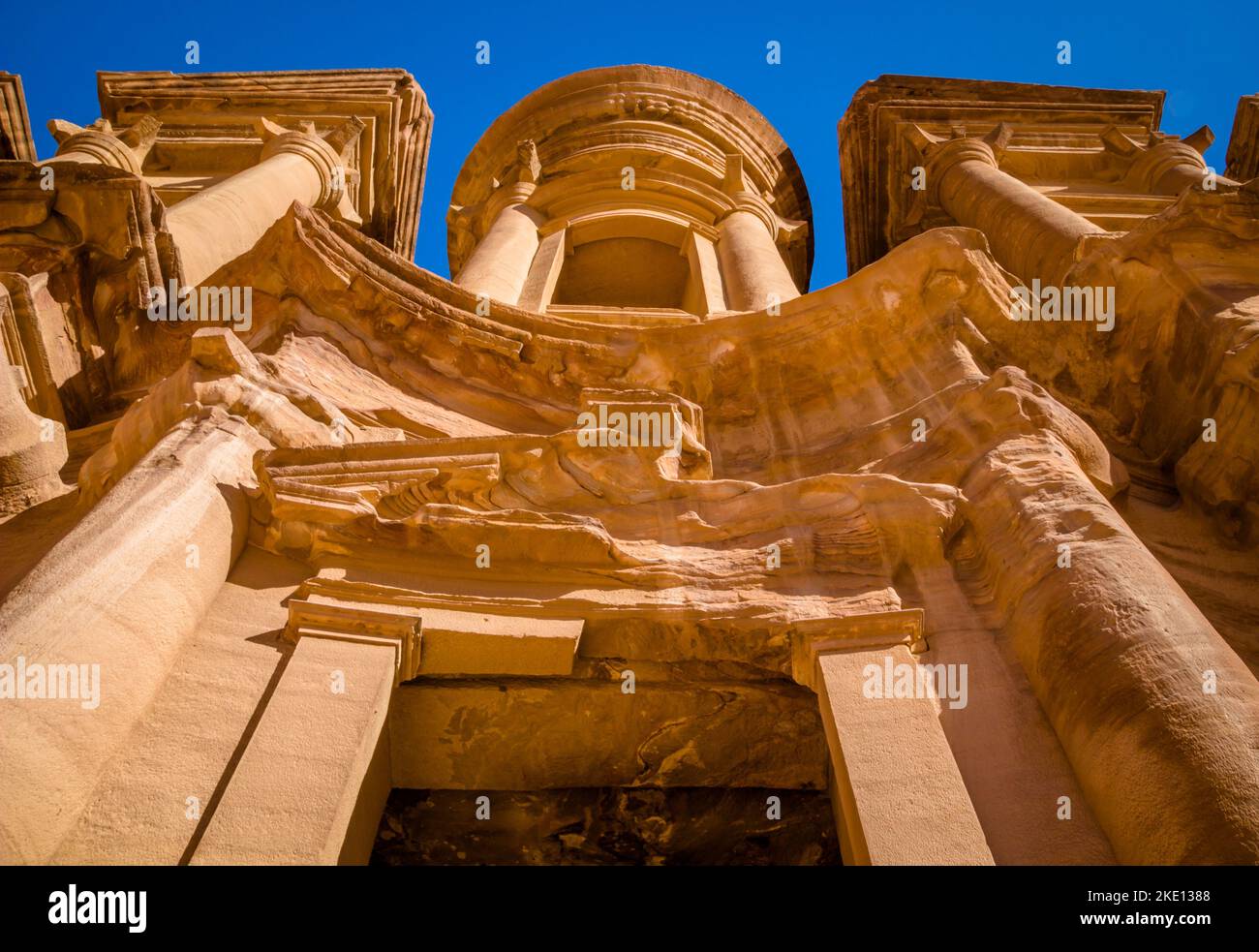 The mesmerizing low angle shot of the historic Petra Monastery in ...