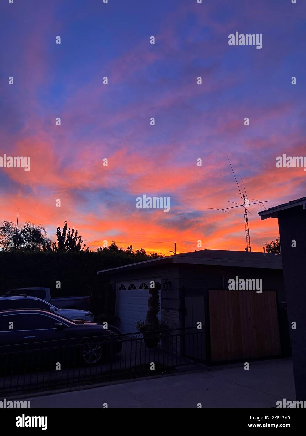 A vertical shot of a beautiful sunset sky over the backyard with a ...