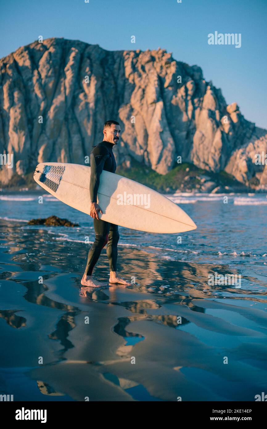 Middle aged surfer looks onward at the waves Stock Photo - Alamy