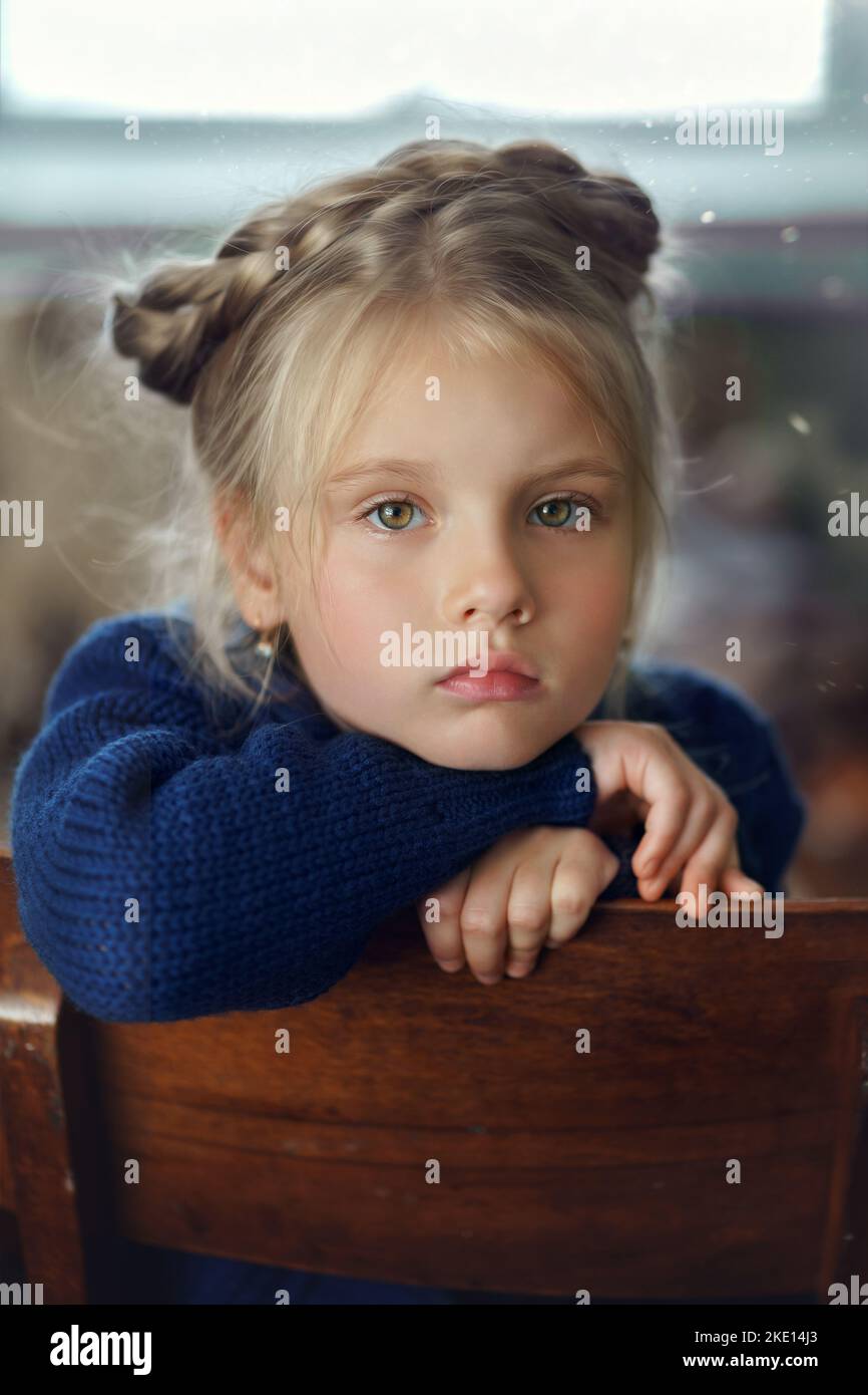 cute girl sitting on a chair Stock Photo - Alamy