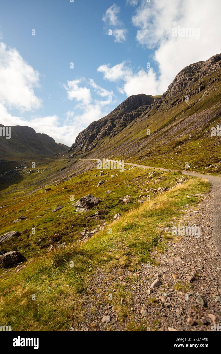 A vertical shot of a bright sunny day in a countryside mountainous ...