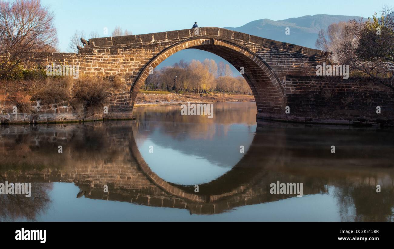 The old Yujin Bridge over the reflecting water, at dawn in the fall of ...