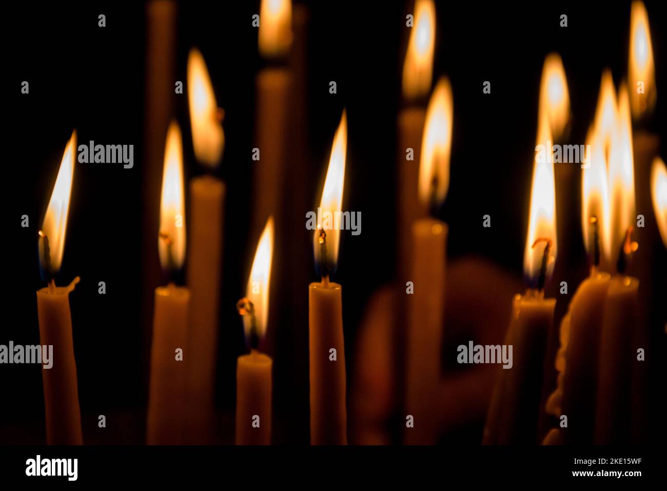 The dramatic lit candles on the black background Stock Photo - Alamy