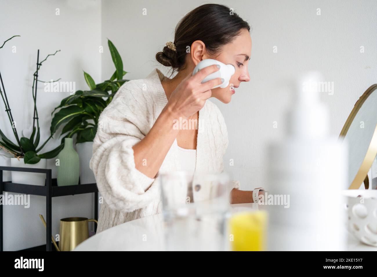 woman is using a micro current device at home on her face Stock Photo ...