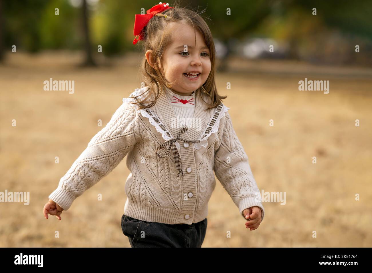Outdoor portrait of an euphoric three years old little girl running ...