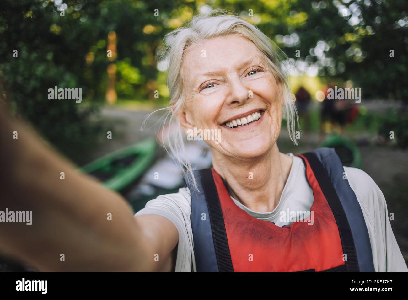 Happy senior woman taking selfie wearing life jacket Stock Photo - Alamy