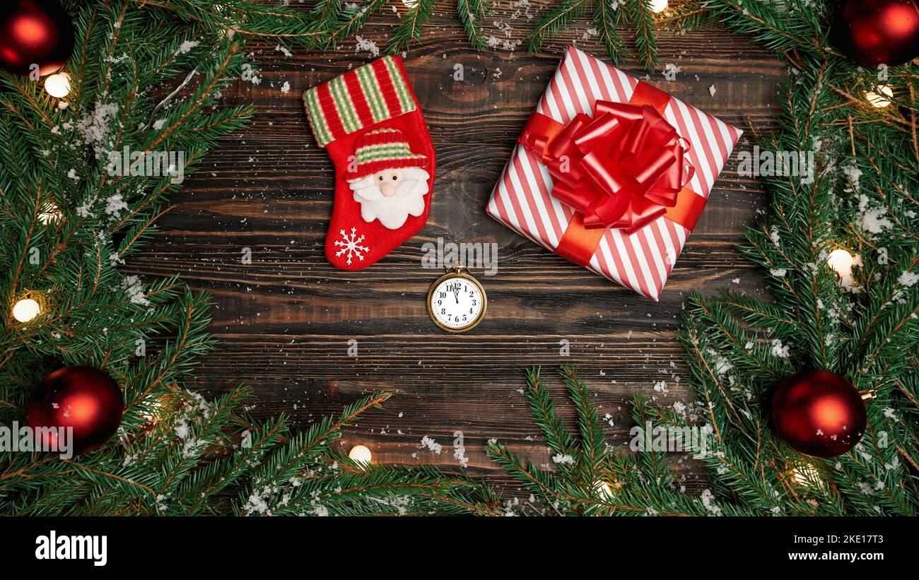 clock, Christmas stocking and a gift on a wooden background Stock Photo ...