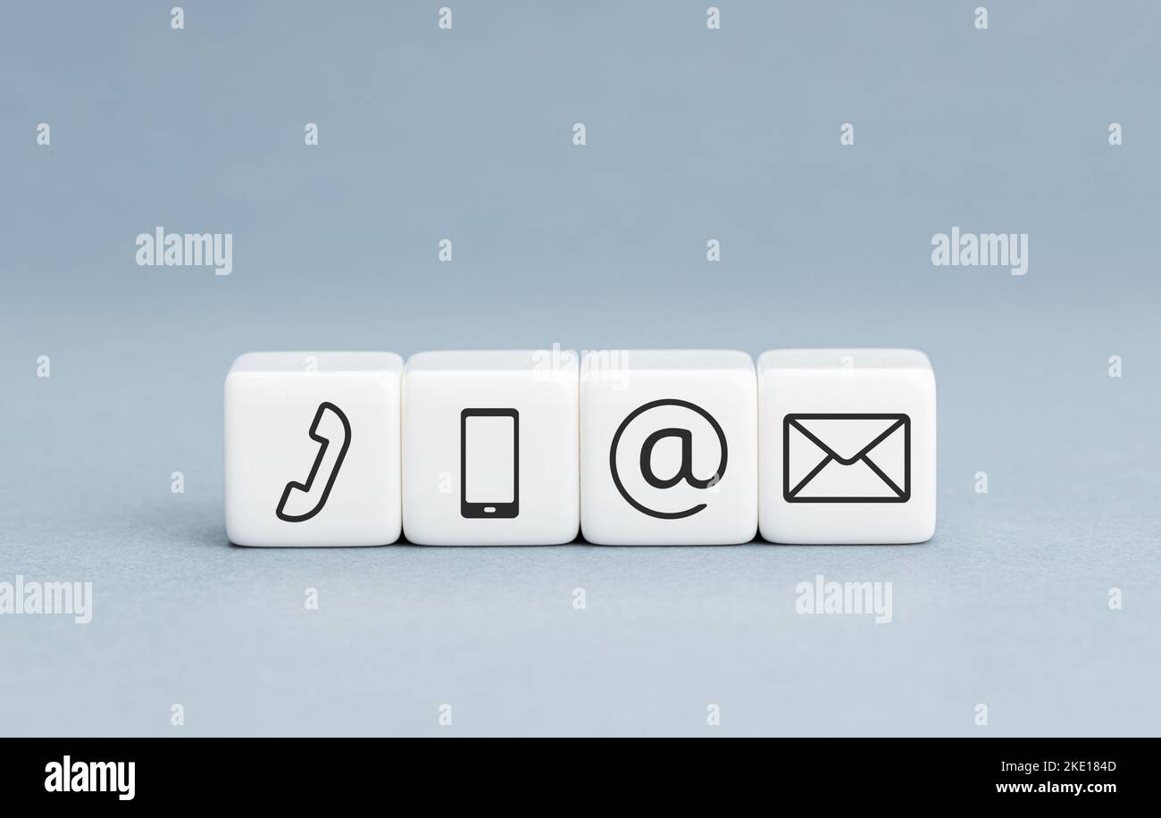 Contact us icons on white cube blocks on blue background. Copy space ...