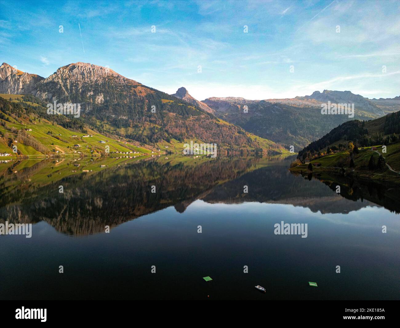 A beautiful landscape with Wagitalersee river reflecting forested ...