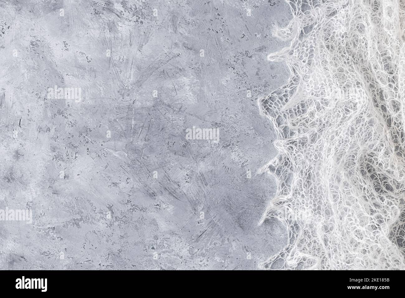 Woolen knitted warm shawl on neutral grey background. Copy space. Flat ...