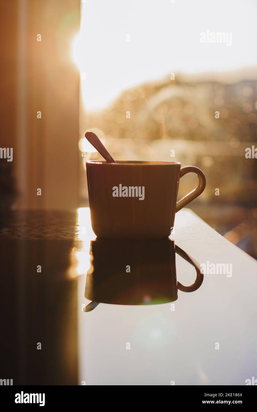 Close up of steaming cup of coffee or tea on vintage table - early ...