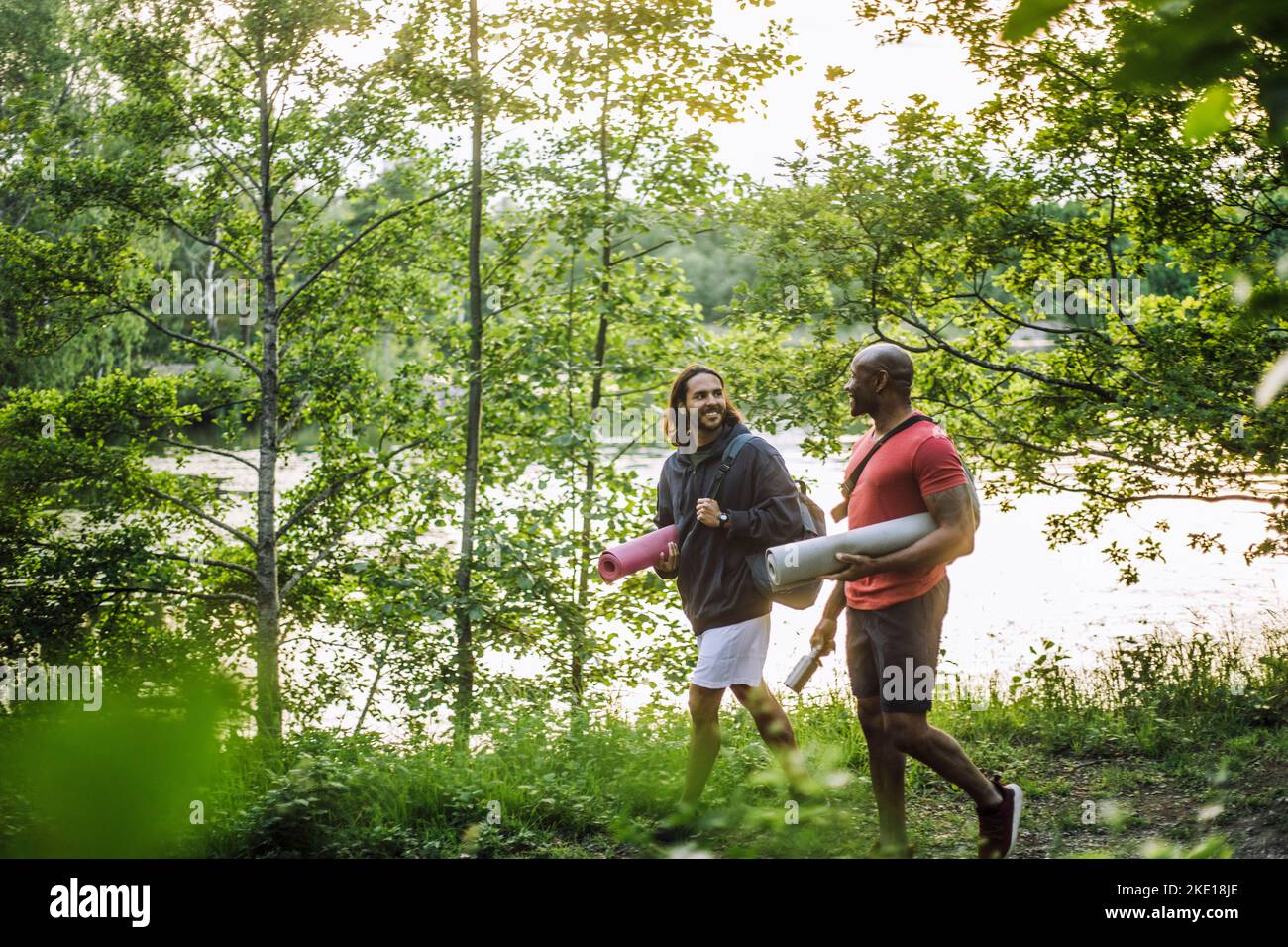 Two male friends carrying mats hi-res stock photography and images - Alamy