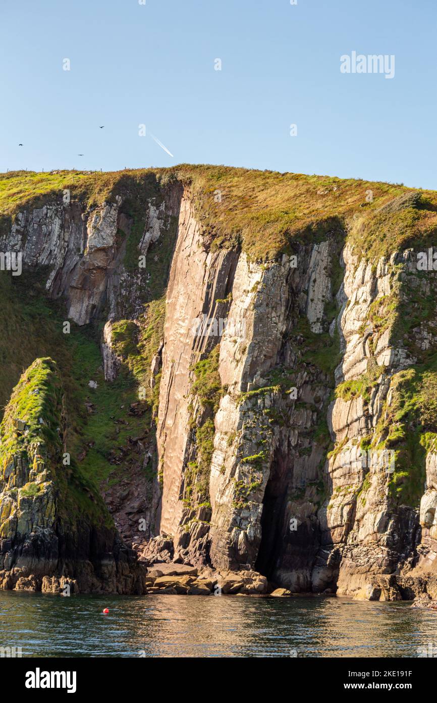 A high rocky cliff near the ocean with a blue sky background Stock ...