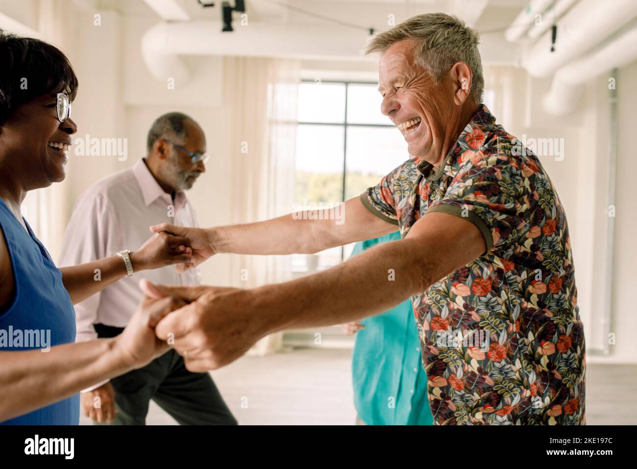 Dancing smiling holding hands enjoyment fun hi-res stock photography ...