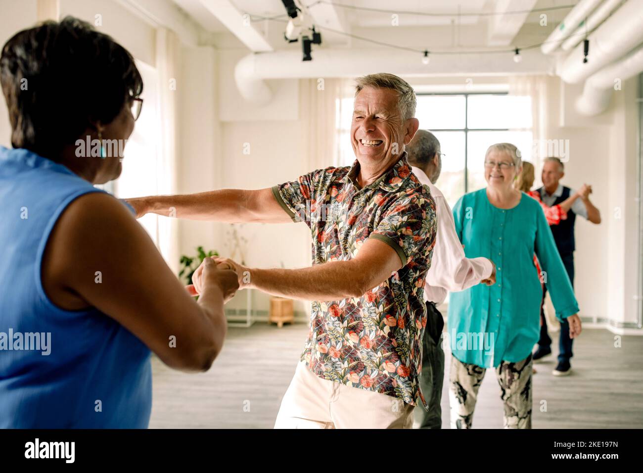 Happy multiracial senior couple dancing together in class Stock Photo ...