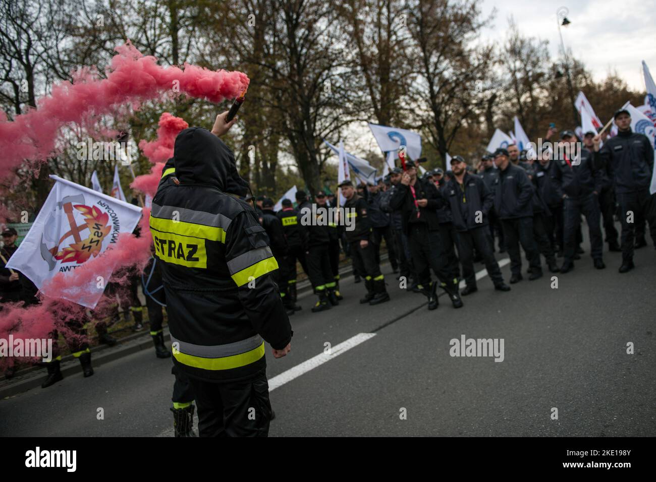 Firemen hold burning flares during the Polish uniformed services ...