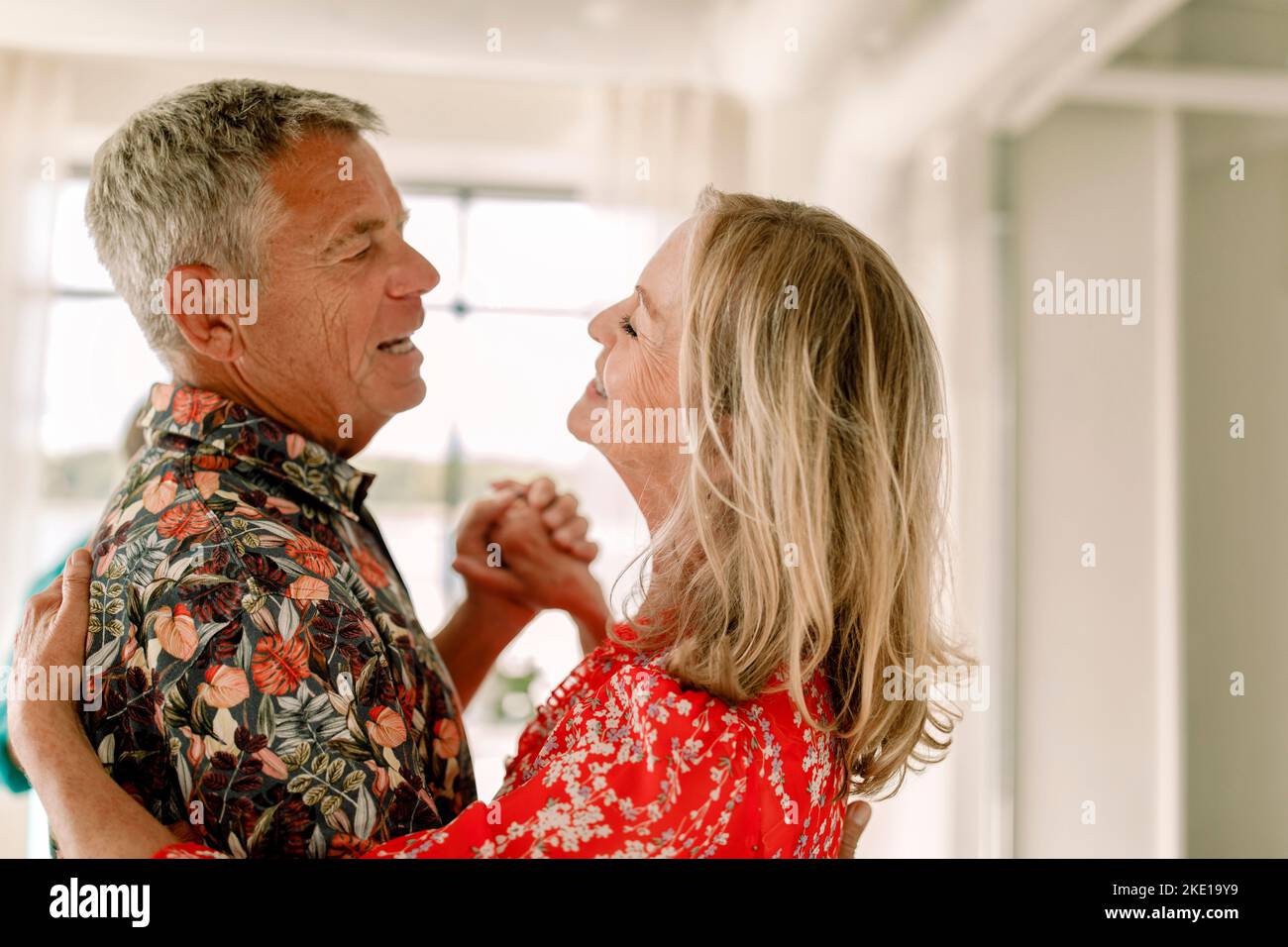 Senior man singing while dancing with blond woman in class Stock Photo ...