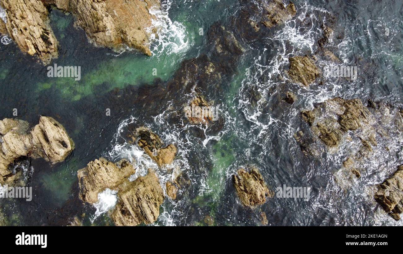 View from above. A lot of boulders in the sea water, top view. Coastal ...