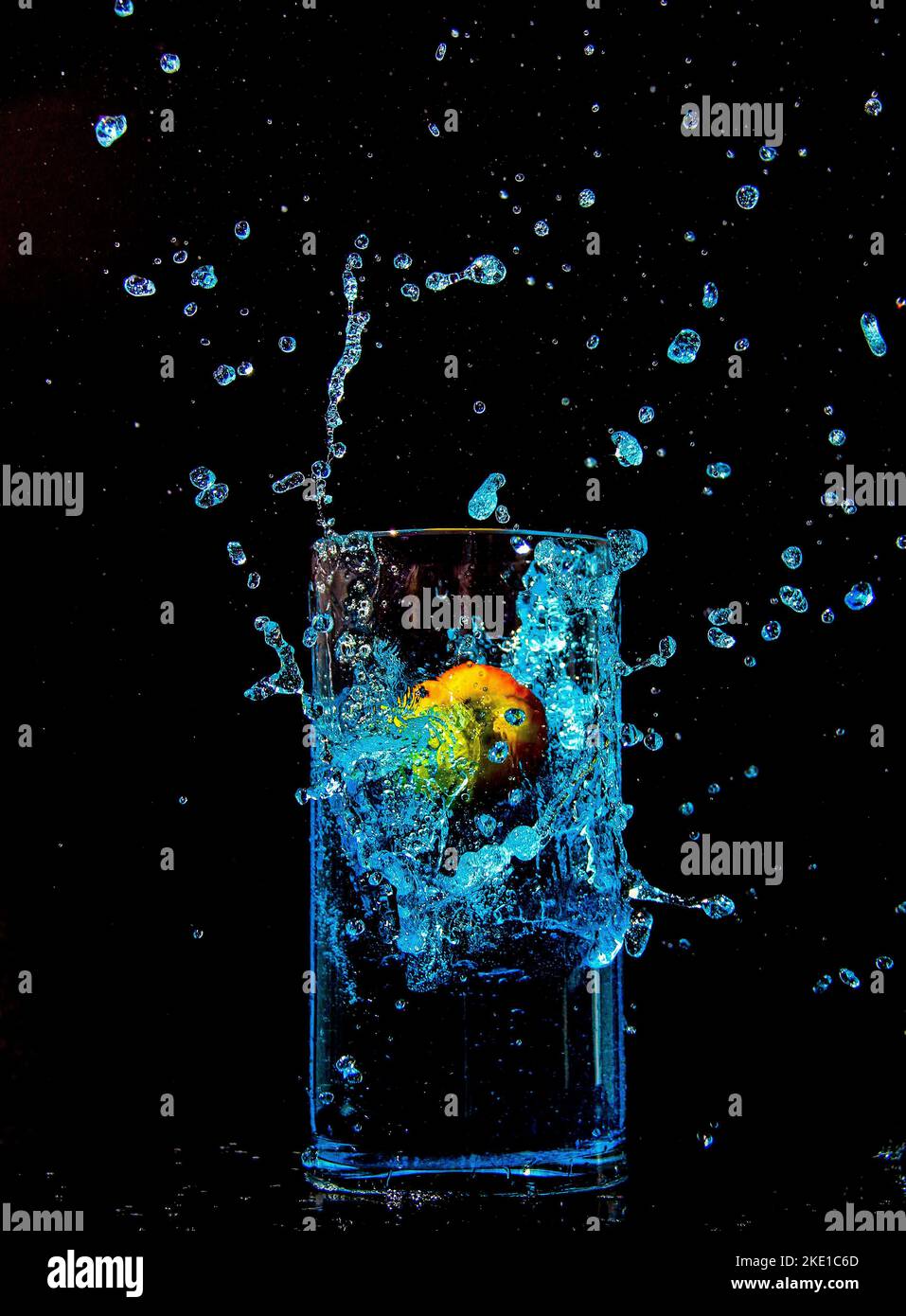 an apple dropping in Water Stock Photo - Alamy