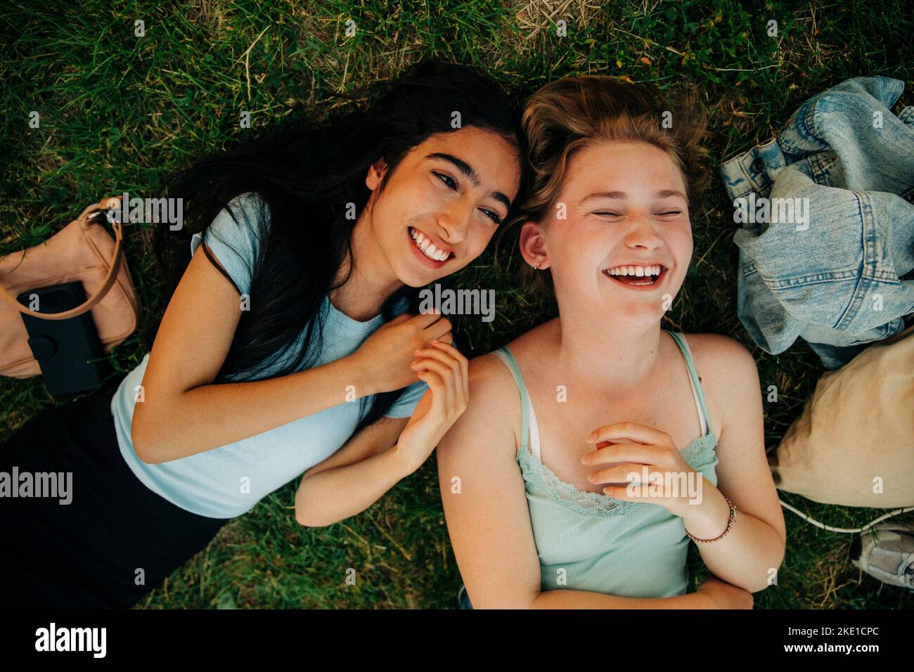 High angle view cheerful of female friends lying on grass Stock Photo ...