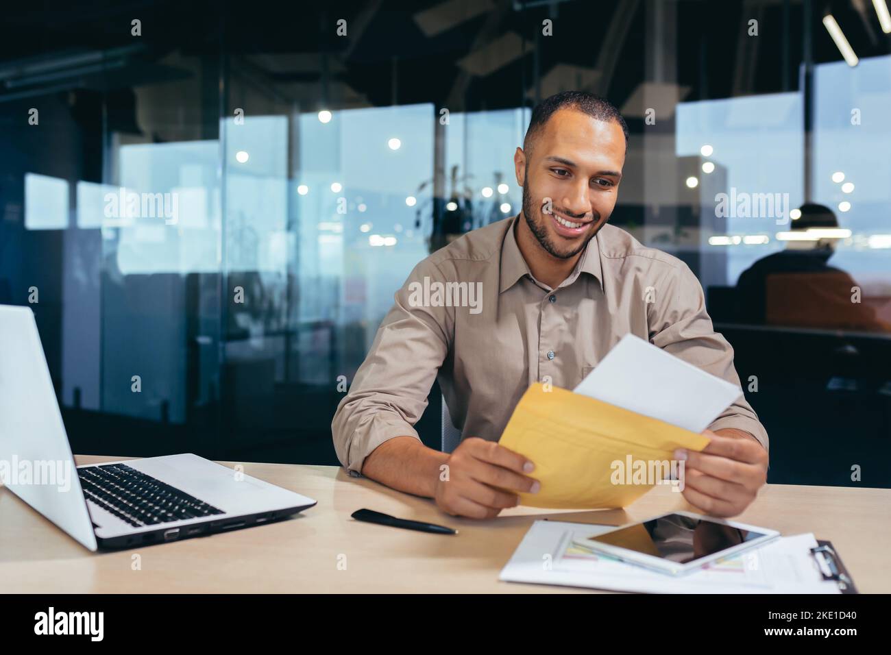 Happy african american businessman financier reading letter from bank ...