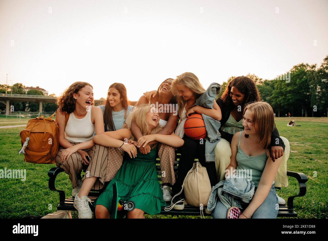 Three girls sitting on bench hi-res stock photography and images - Alamy