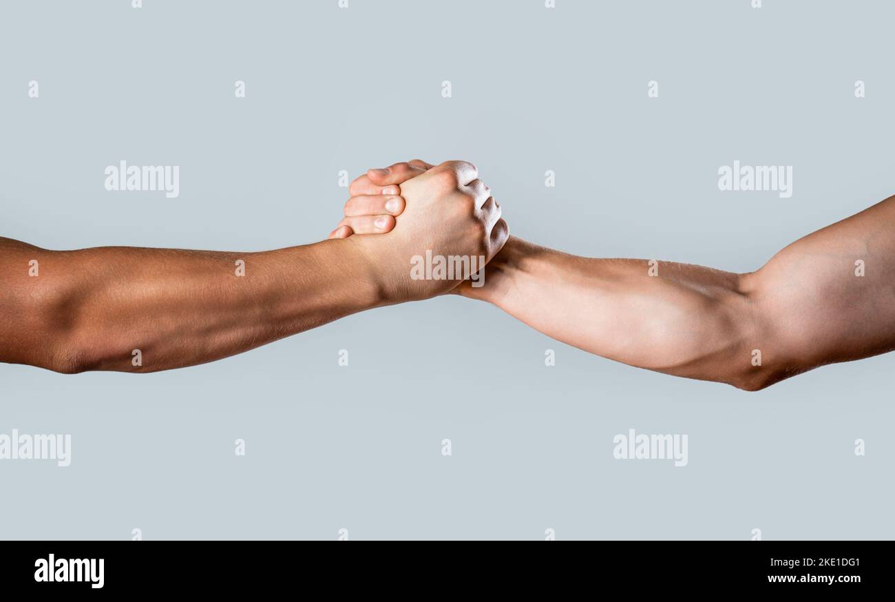 Friendly handshake, friends greeting, teamwork, friendship. Two hands, helping arm of a friend ...