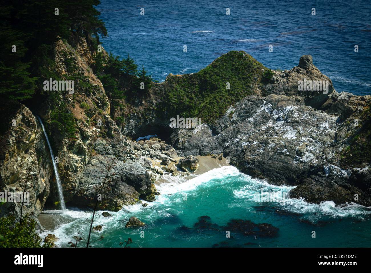 A beautiful view of a waterfall on a rocky seashore Stock Photo - Alamy