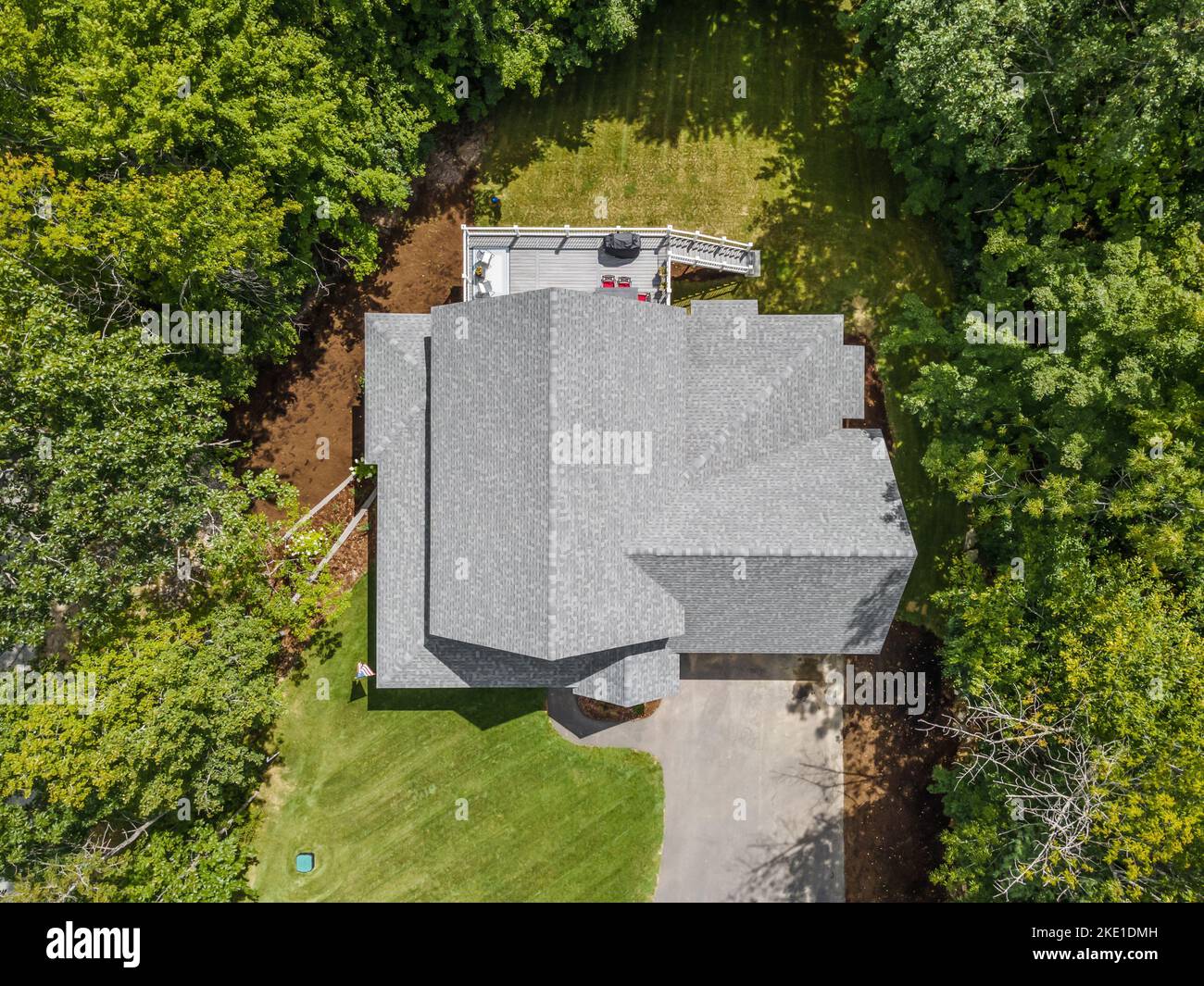 An aerial shot of a house surrounded by dense vegetation in New England ...