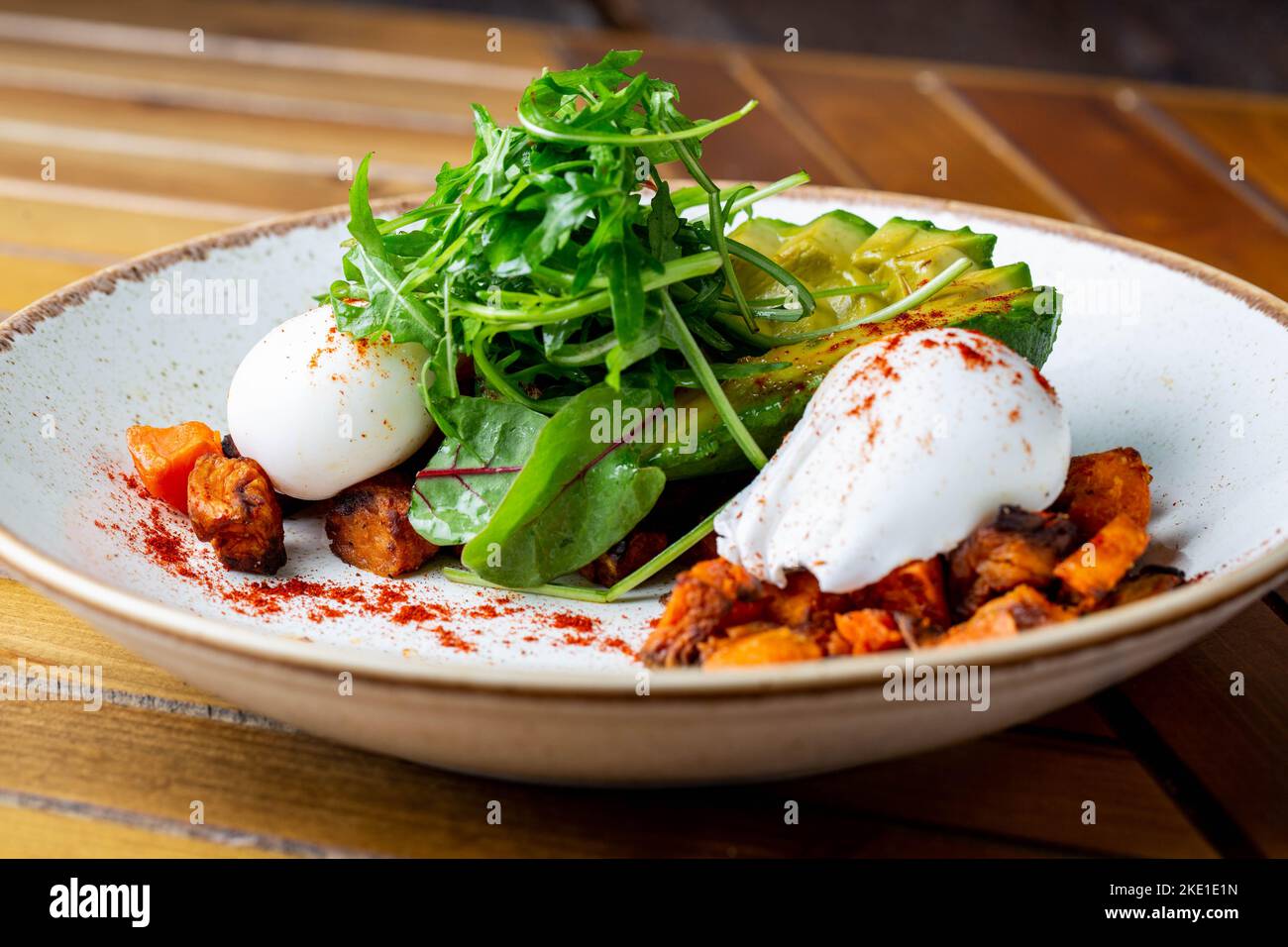 A healthy homemade meal of sweet potato cubes, rocket salad with ...