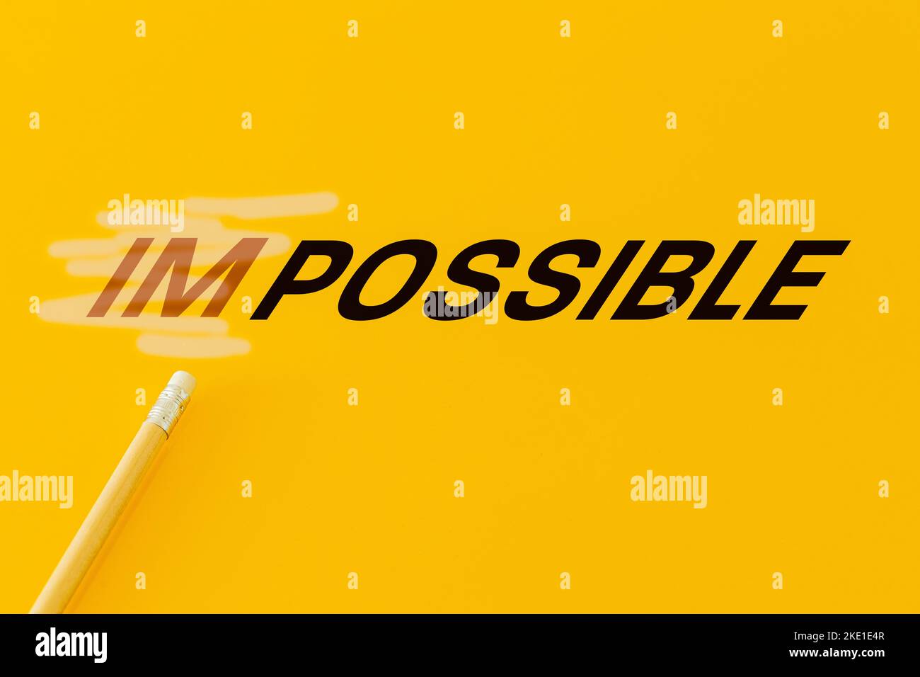 Concept of positive thinking, word impossible erased with an eraser and ...