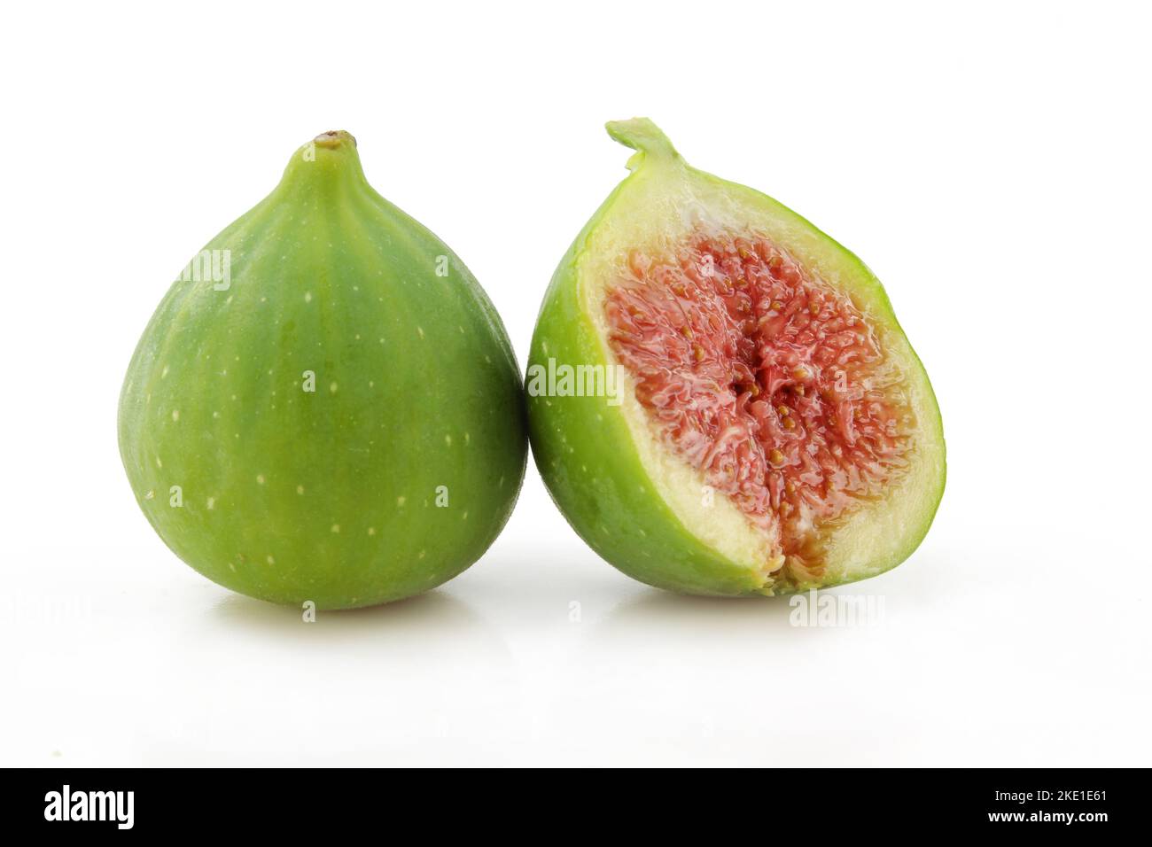 One whole green and sliced fig isolated on white background Stock Photo ...