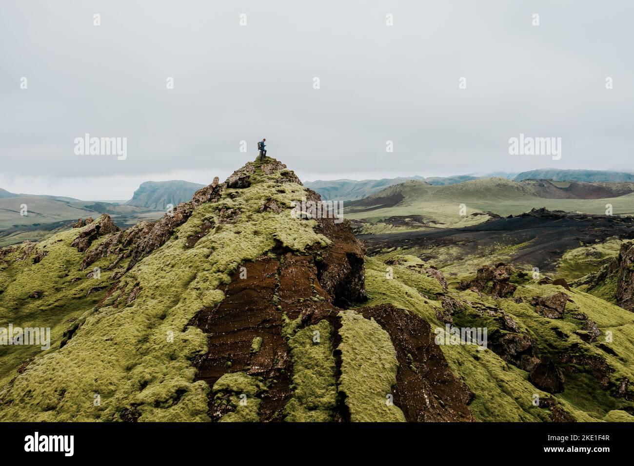 An aerial view of a man on the mountaintop of the Iceland Moss ...