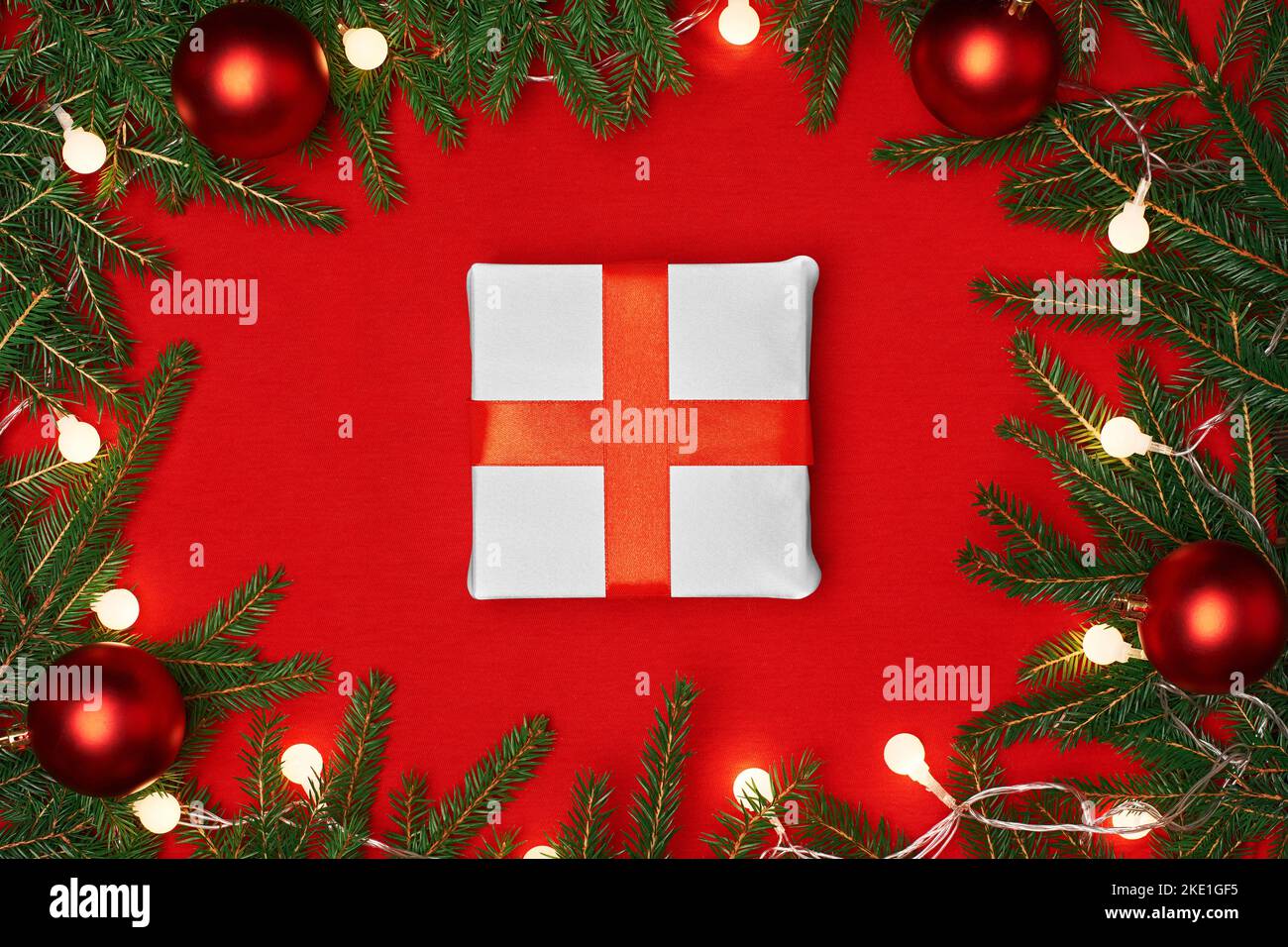 Christmas gift on a red festive background Stock Photo - Alamy