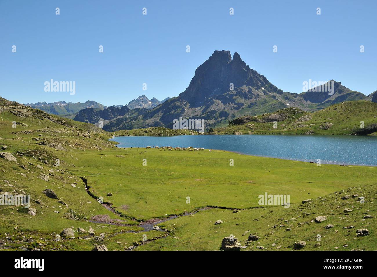 A low-angle of a landscape with Lacs d'Ayous lake view, meadow around ...